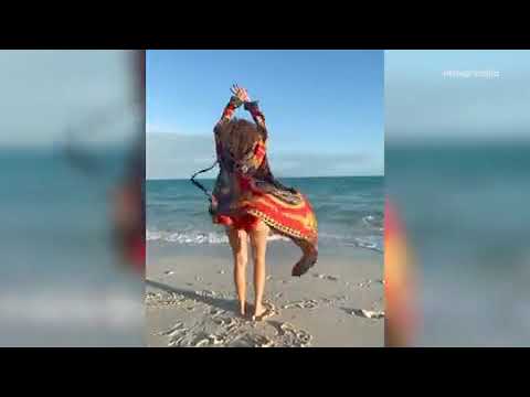 Jennifer Lopez enjoys the beach in skimpy red bikini and robe