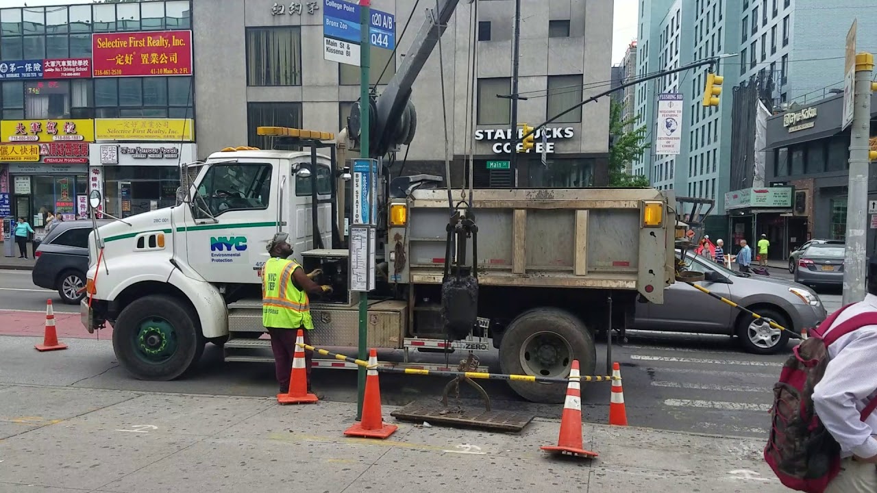 DEP field operations employee cleans out a sewer catch basin - YouTube