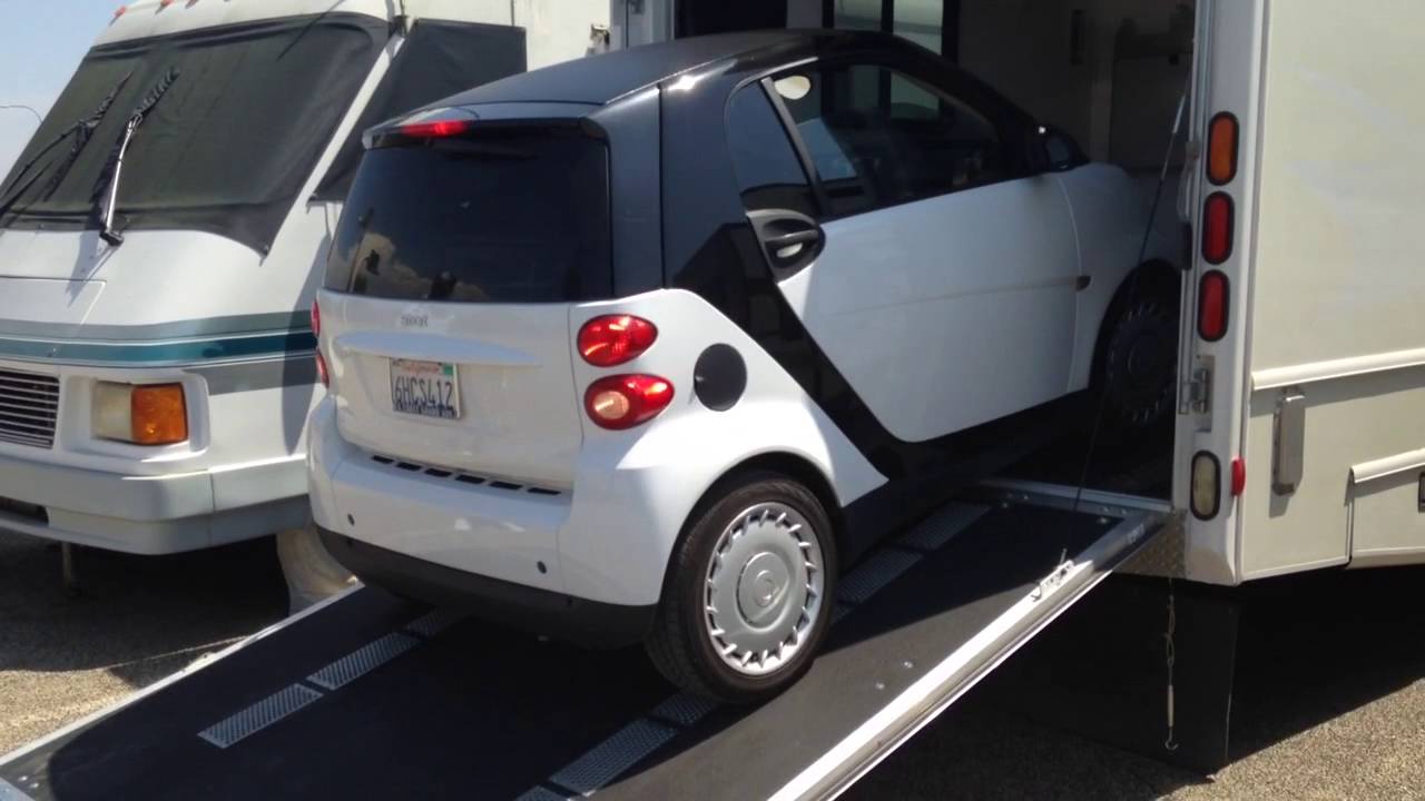 Smart For Two unloading from an Outlaw RV Class A Toy Hauler - YouTube