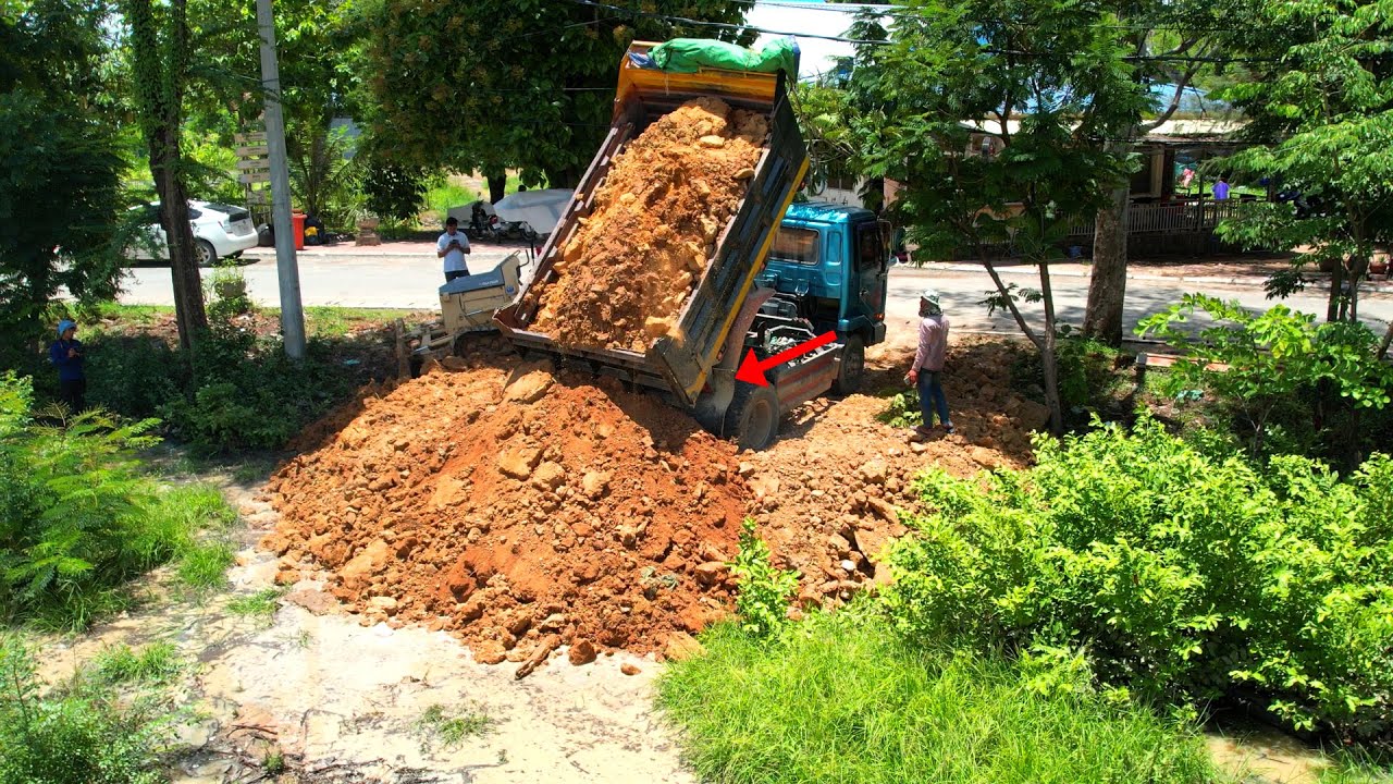 Incredible dump truck unloading dirt and bulldozer pushing spreading ...