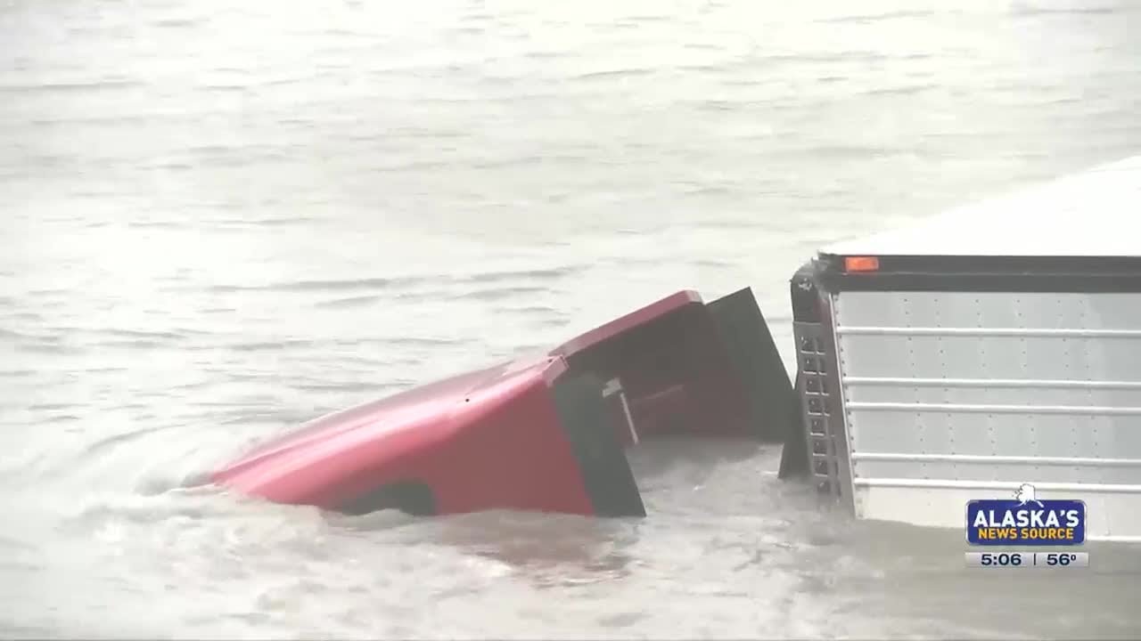 Crews work to pull semi-truck out of water after splashing into ...