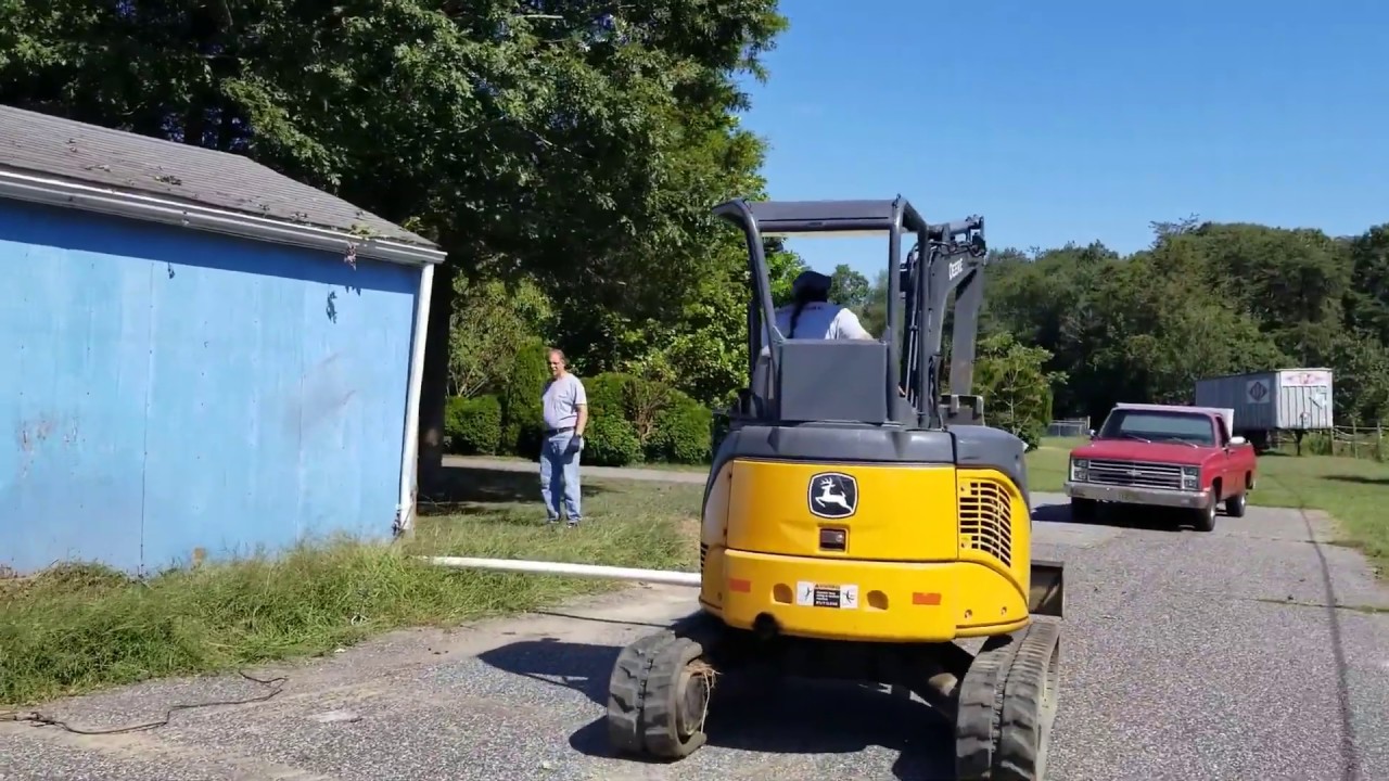 Moving a building With a Small Excavator - YouTube