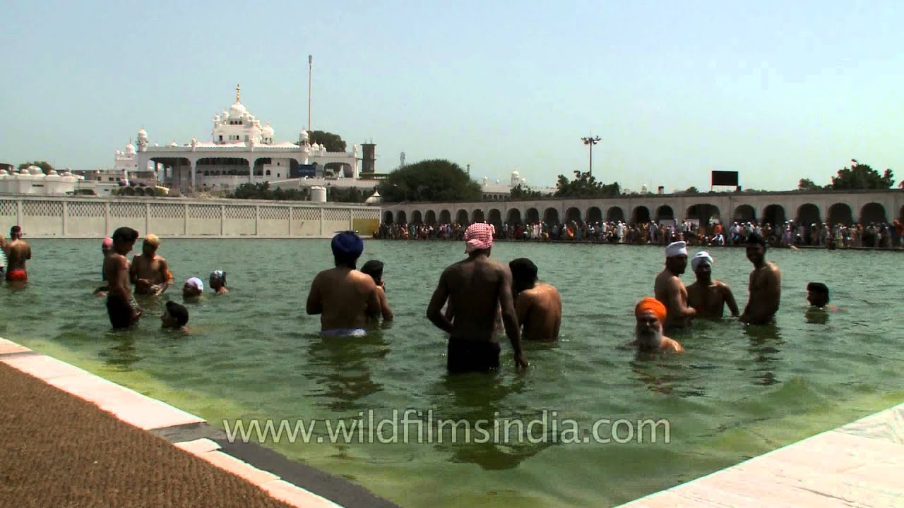 Sikh devotees performing holy bath on Baisakhi at the sarovar in ...