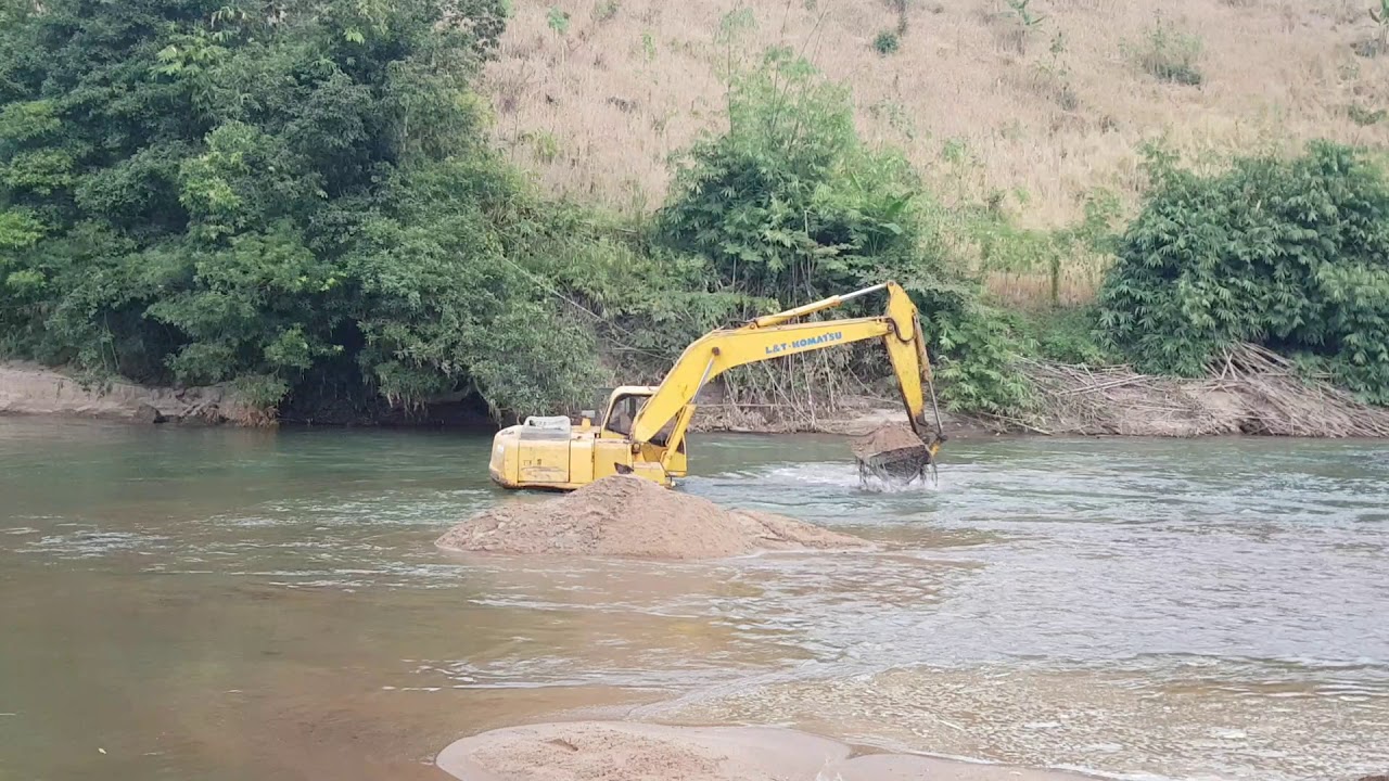 Excavator working in the middle of the river - YouTube