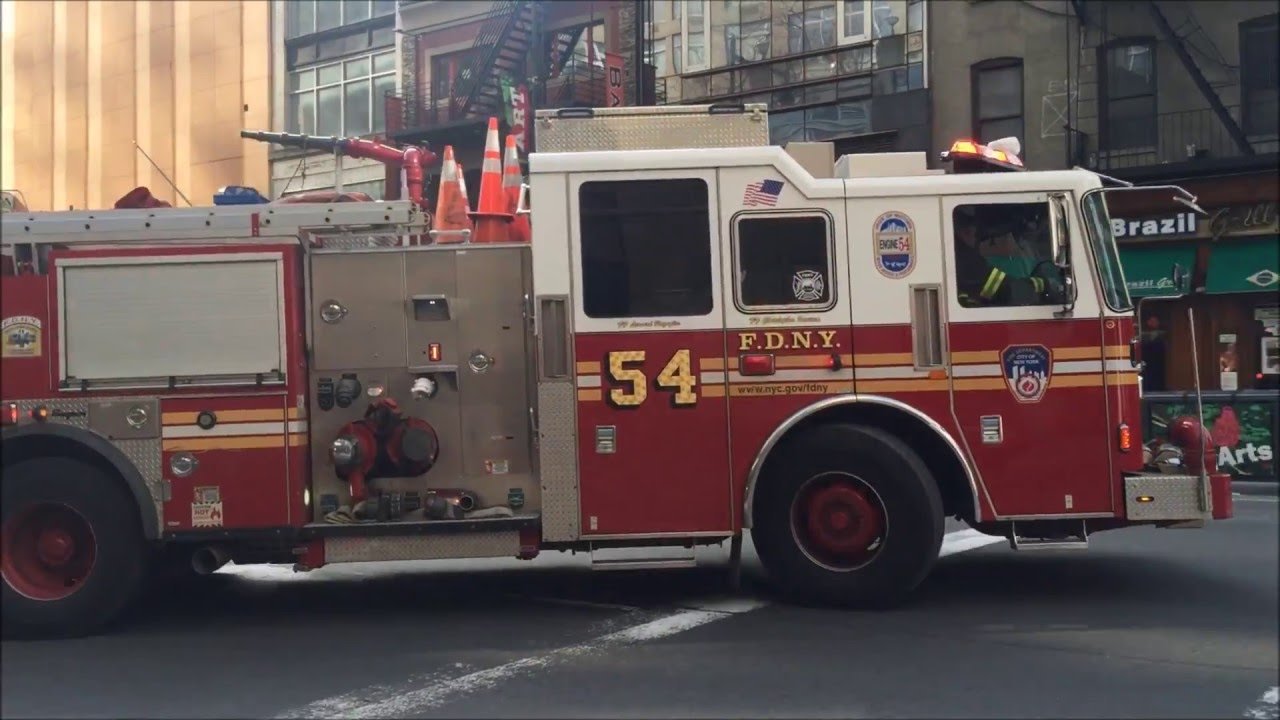 FDNY ENGINE 54 RESPONDING FROM IT'S FIREHOUSE ON 8TH AVENUE IN MIDTOWN ...