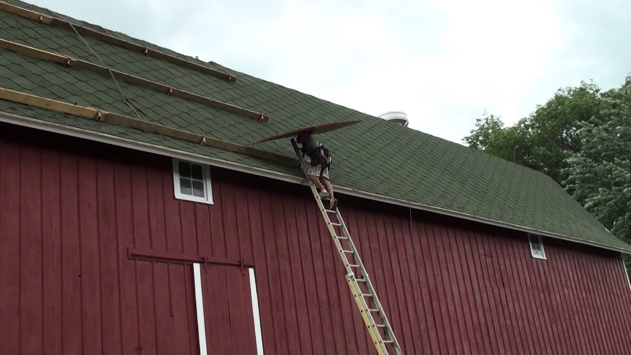Cody takes plywood up a ladder in high wind on a BARN!!! - YouTube