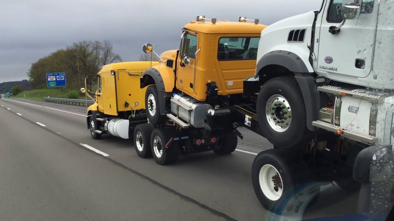 Brand new Mack trucks on the interstate - piggy back - YouTube