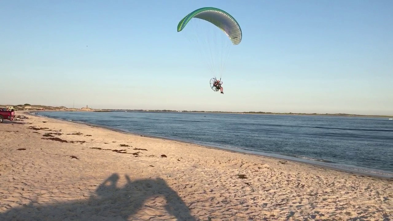 Crazy man flies around the beach with some weird contraption on his ...