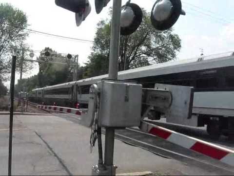 Nj transit pulls out of Radburn station over the level crossing - YouTube