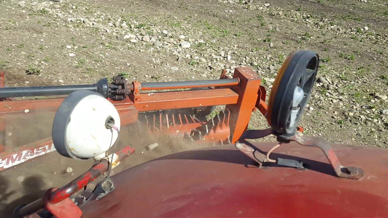 Rock-master rock rake / rock windrower pulled by 1206 IH part 1 - YouTube