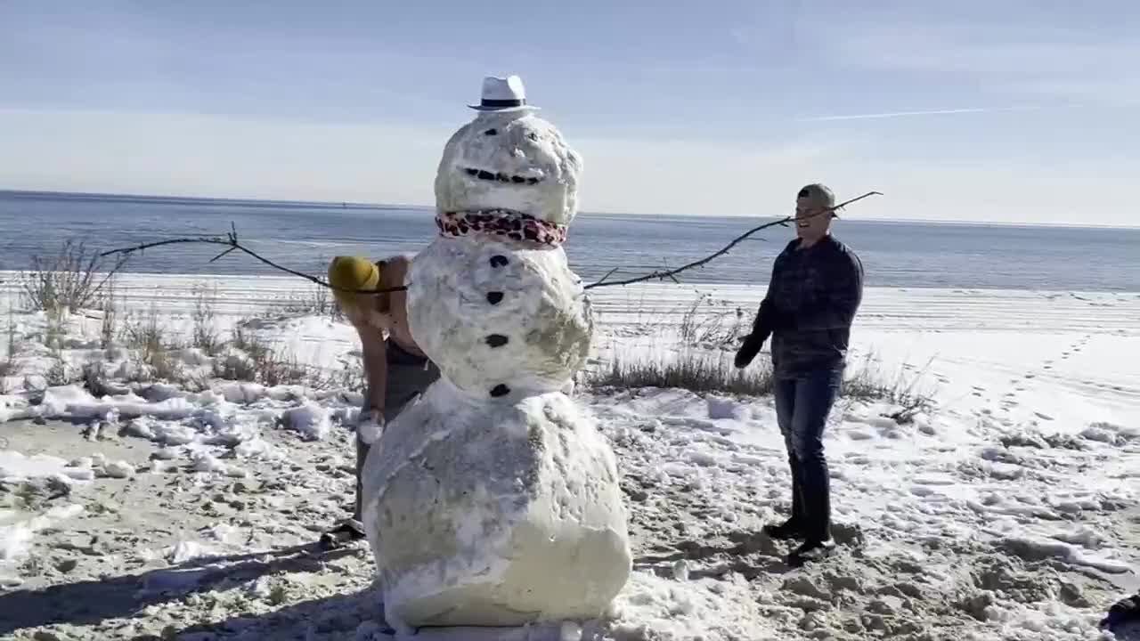 A sight to see: Snowmen on the beach! - YouTube