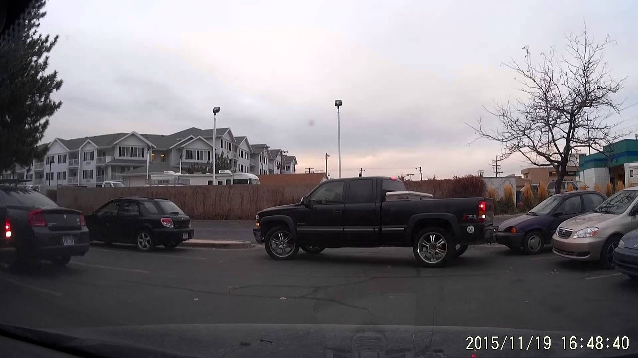 Truck backs up into car - YouTube