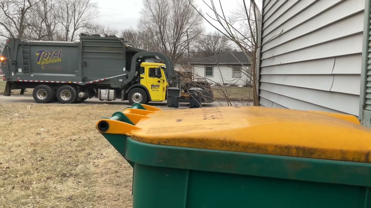 Total garbage truck picking up my garbage cans (bonus I followed it ...