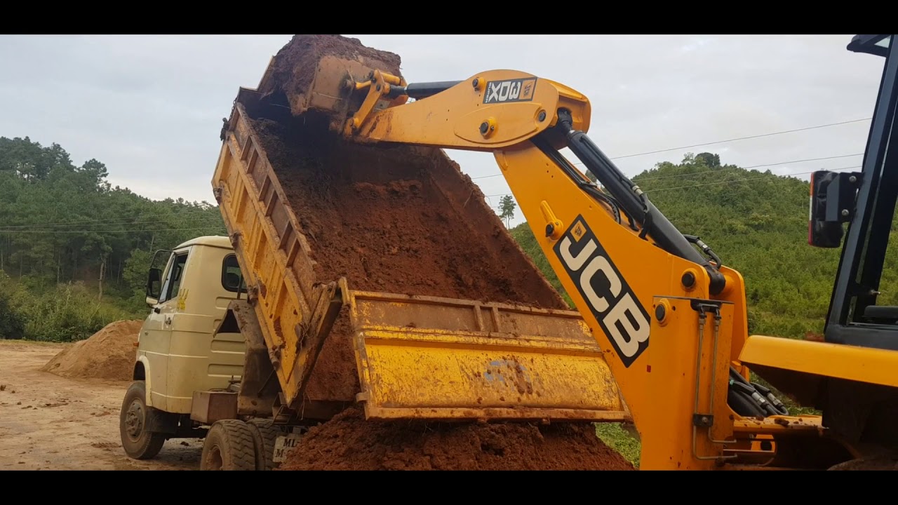 JCB helping a over loaded dump truck / JCB unloading soil from a dump ...