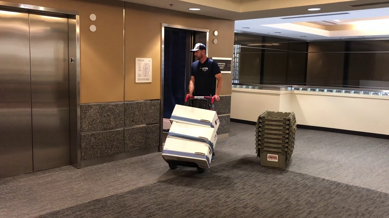 Using hand truck to move file boxes to new office - YouTube