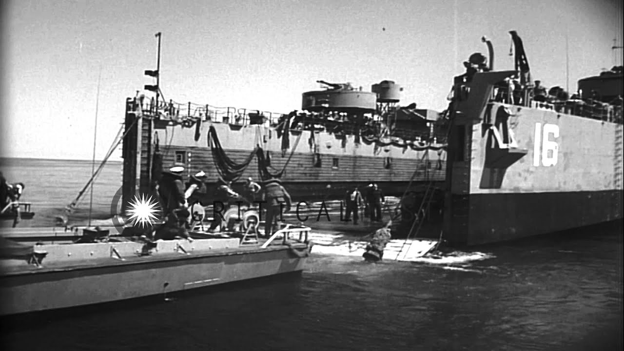 Mine sweep boats back out of an LSD-16 and sweep through the water off ...