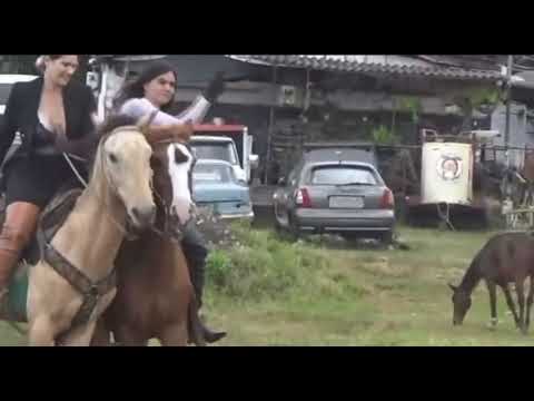 2 ladies riding donkey in a big ground