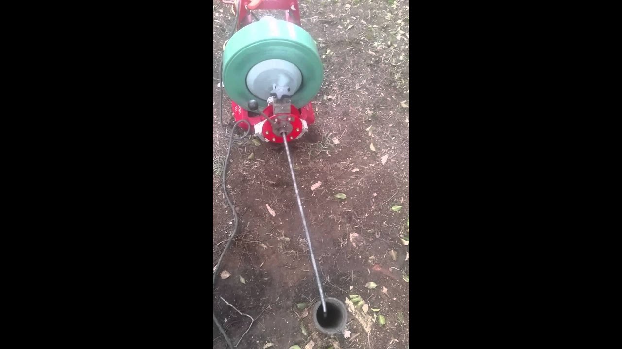 Snaking a main sewer line - YouTube