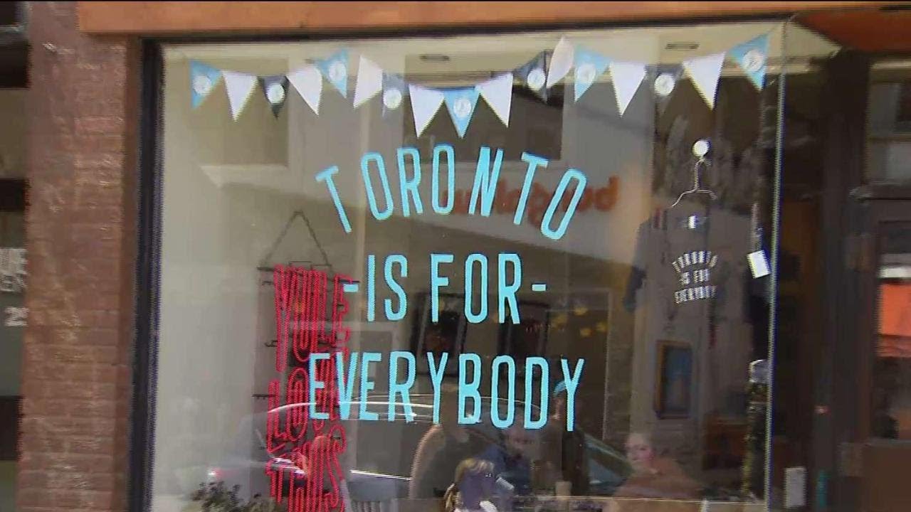 Toronto cafe promotes unity with alternate slogan - YouTube