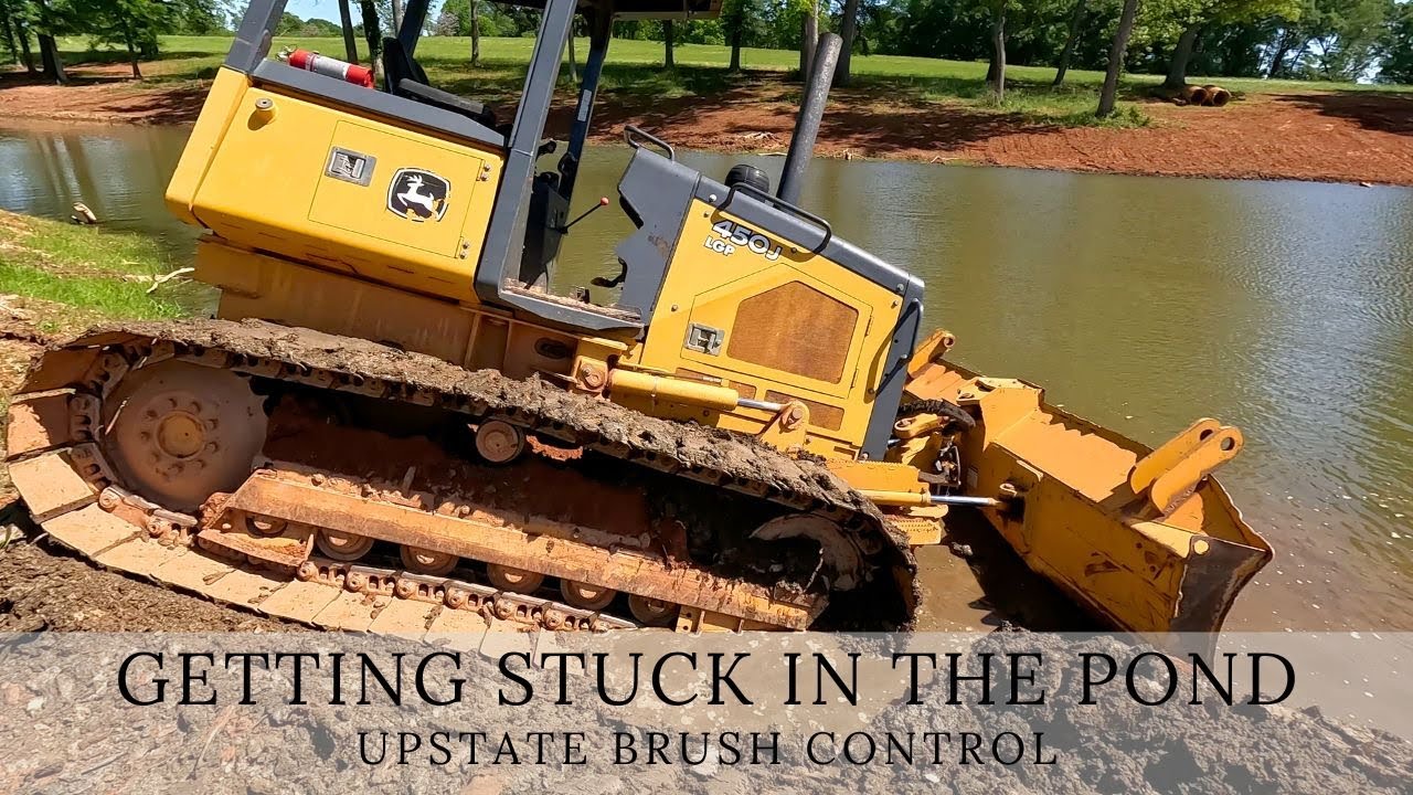 Got the dozer stuck trying to clean up the edges of the pond - YouTube