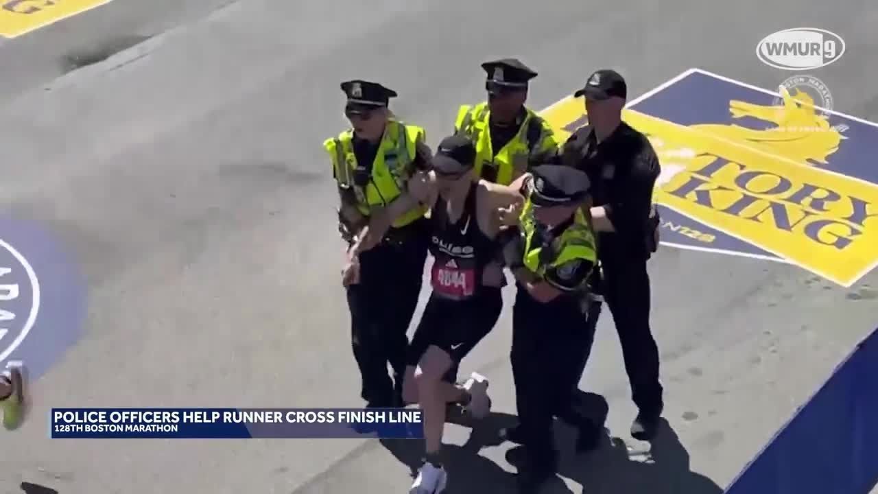 Police officers help runner cross finish line of the 128th Boston ...