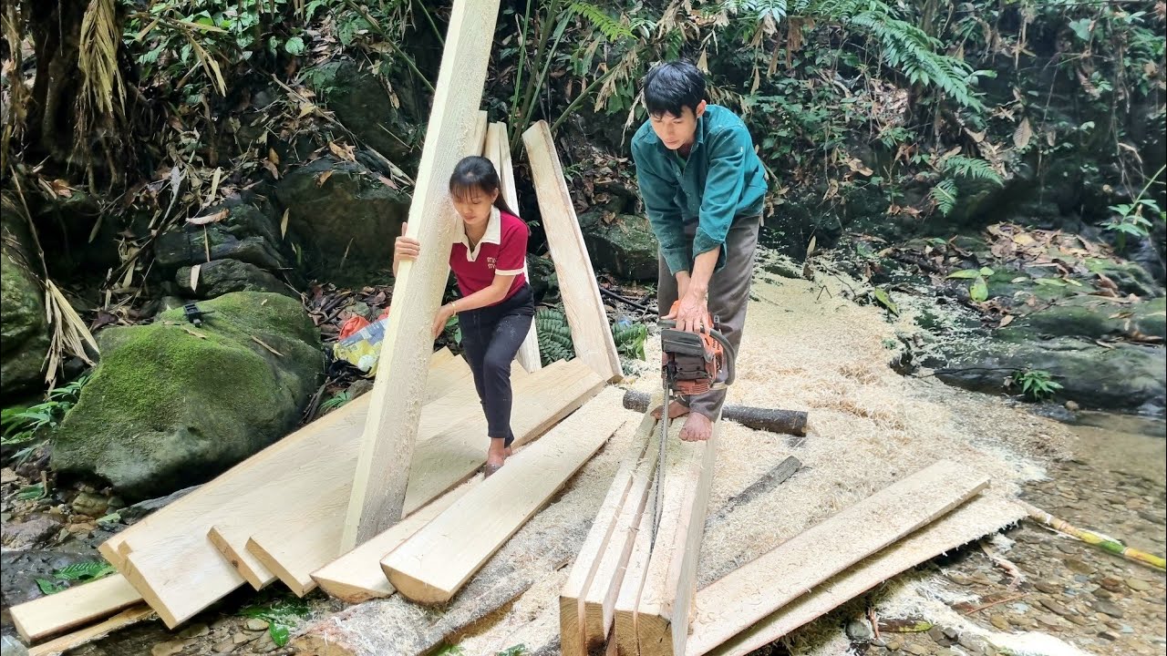 The process of sawing wood in preparation for rebuilding a new barn ...