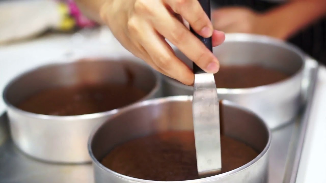 chocolate cake sponge baked in stainless mold freshly made from oven ...