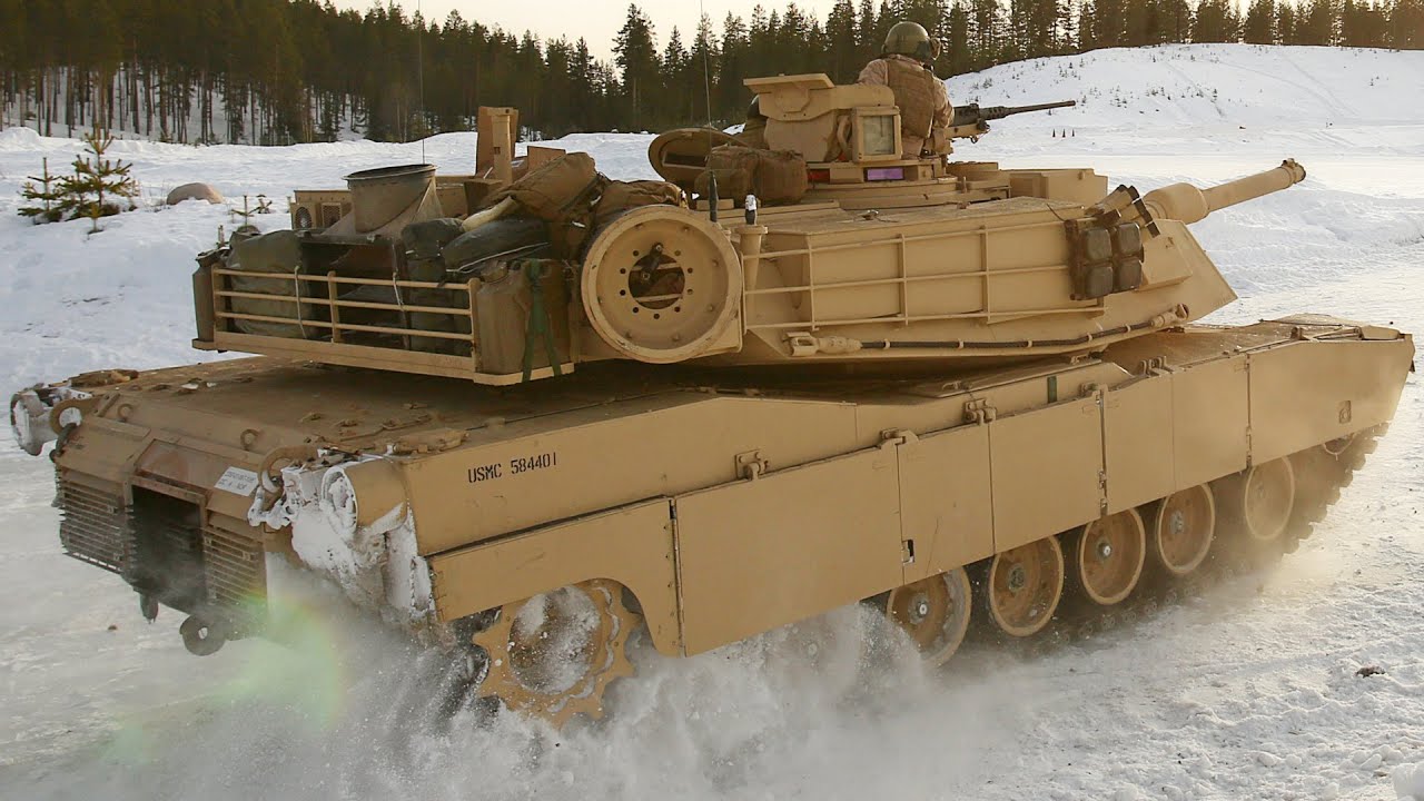 Tanks gliding on the ice. M1A2 Abrams and Leopard 2A4 on an ice track ...
