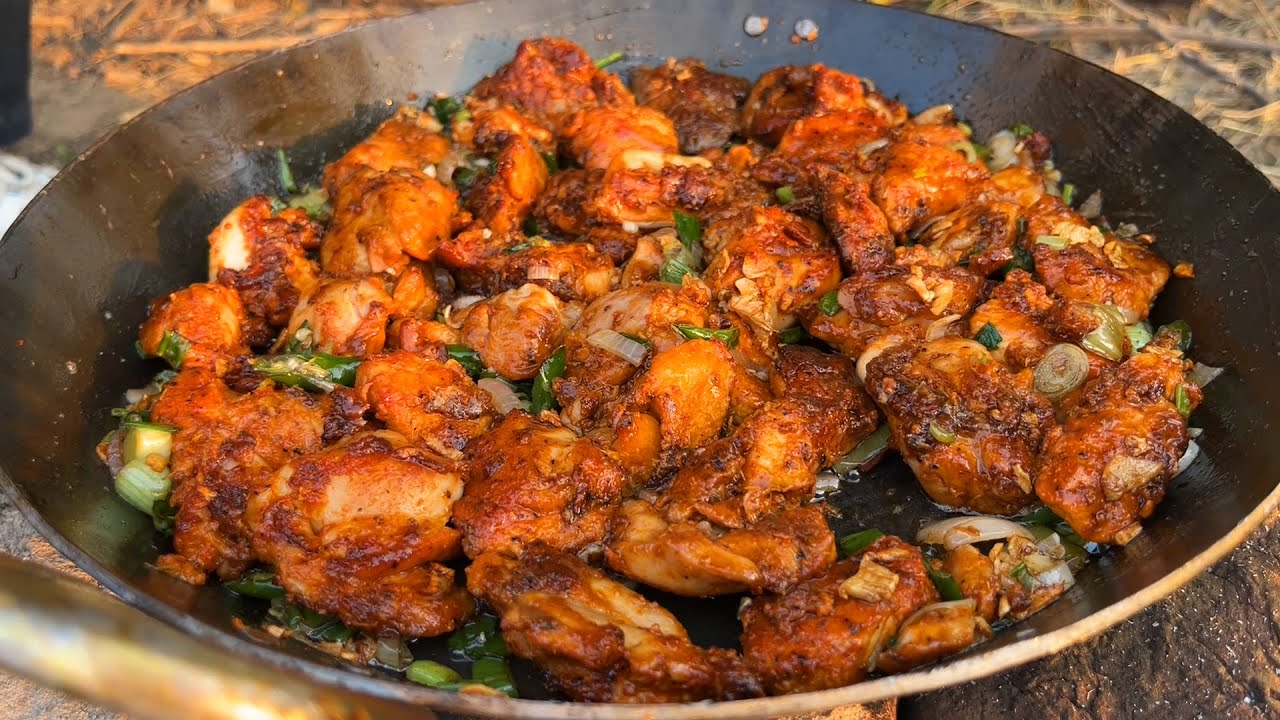 Spicy butter garlic chicken cooked in traditional village utensil ...