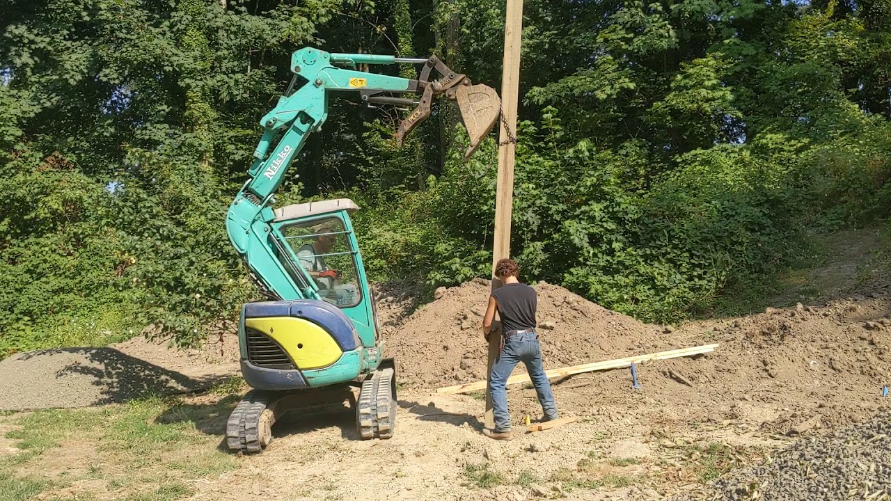Mini Excavator setting a pole - YouTube