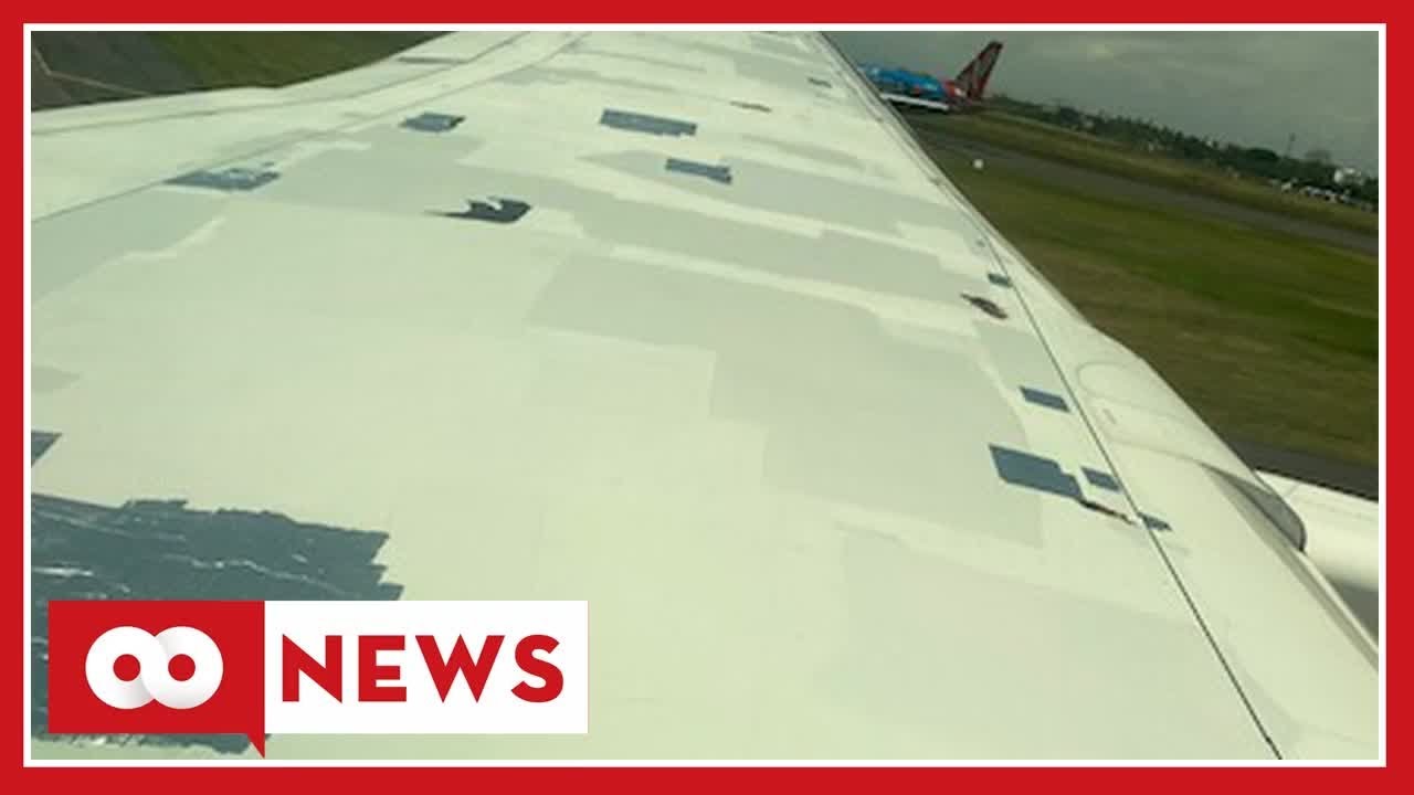 Passenger concerned after spotting tape on wing of plane - YouTube