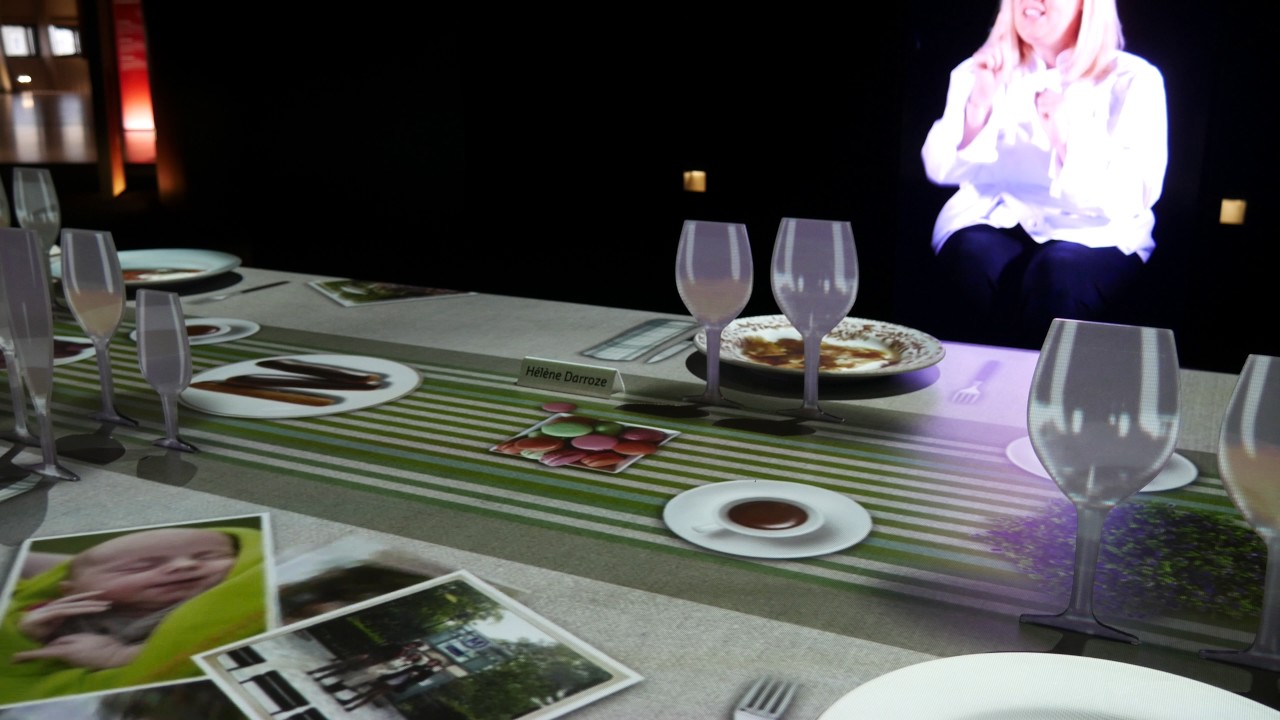 Projection on a dining table synced with vertical screens in La Cité du ...
