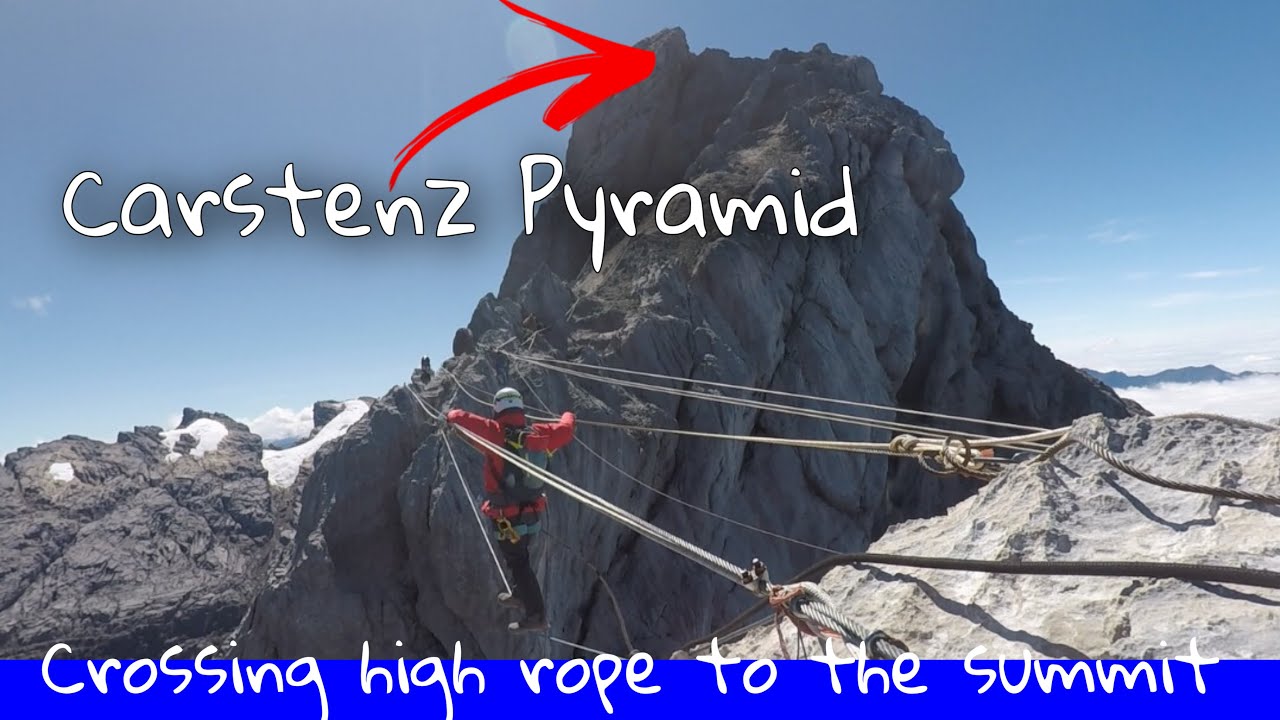 Crossing high rope to the summit of Carztenz Pyramid - YouTube