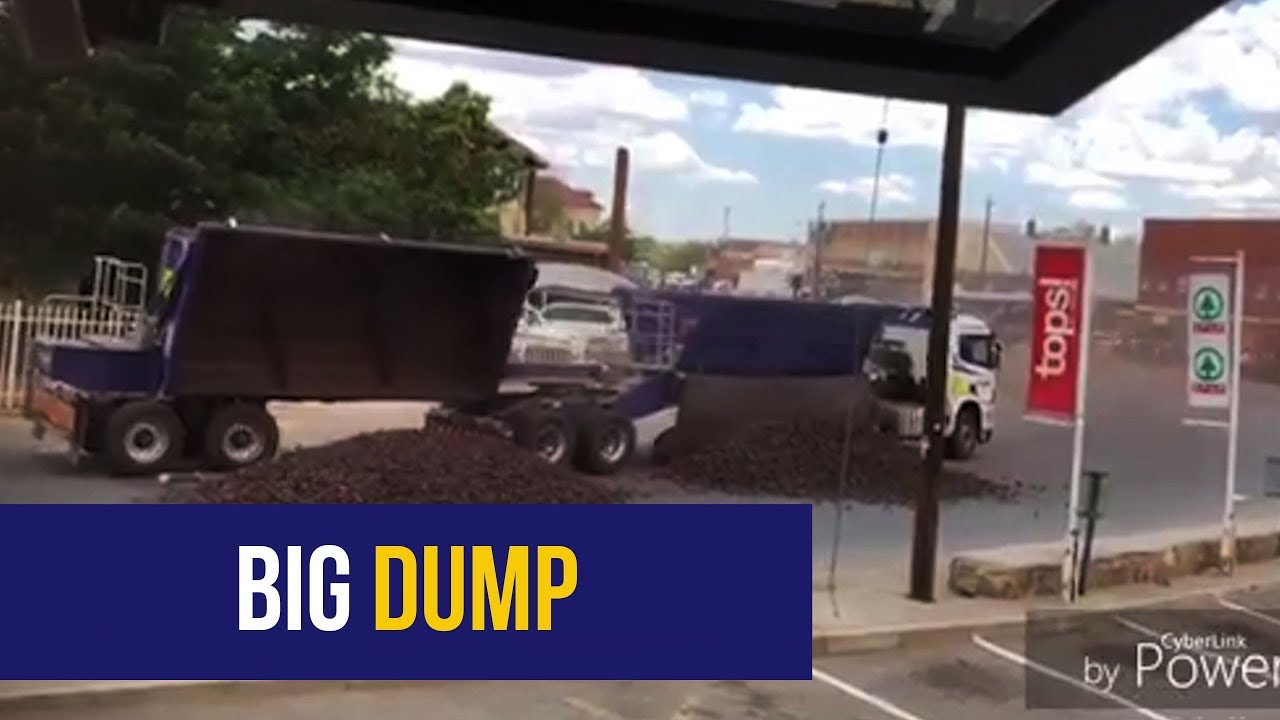 WATCH: Protesters force truck to dump its load onto a public road - YouTube