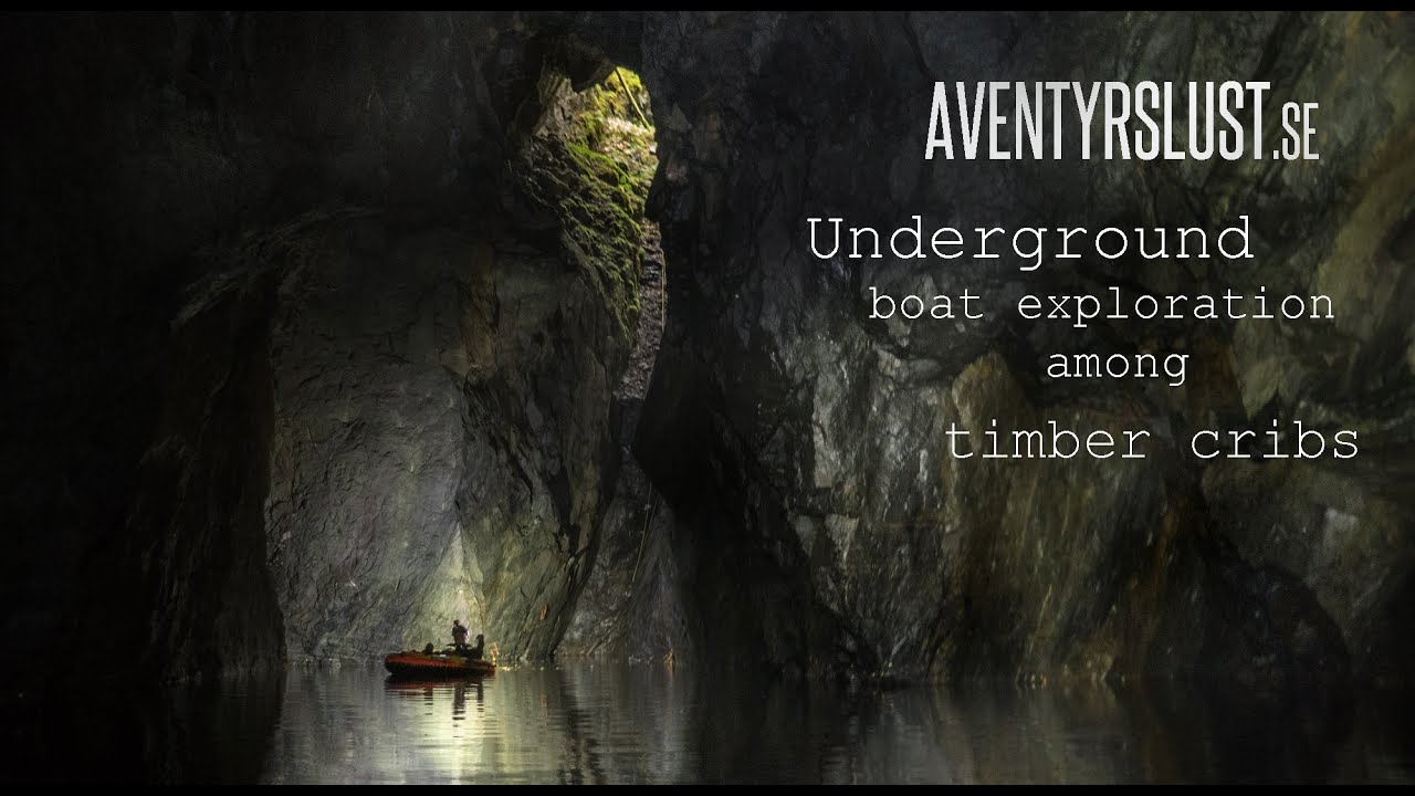 Underground boat exploration among timber cribs in an abandoned mine ...