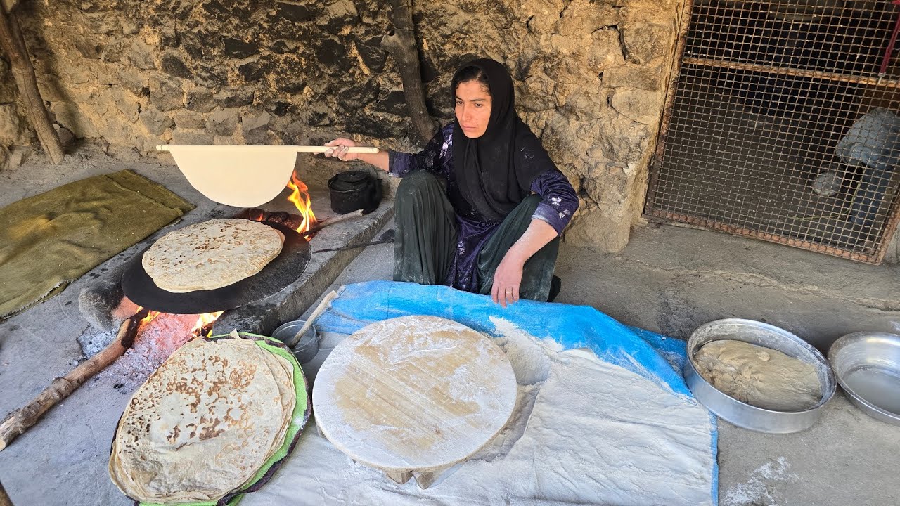 The real life of nomads in the village. Baking local bread by a nomad ...