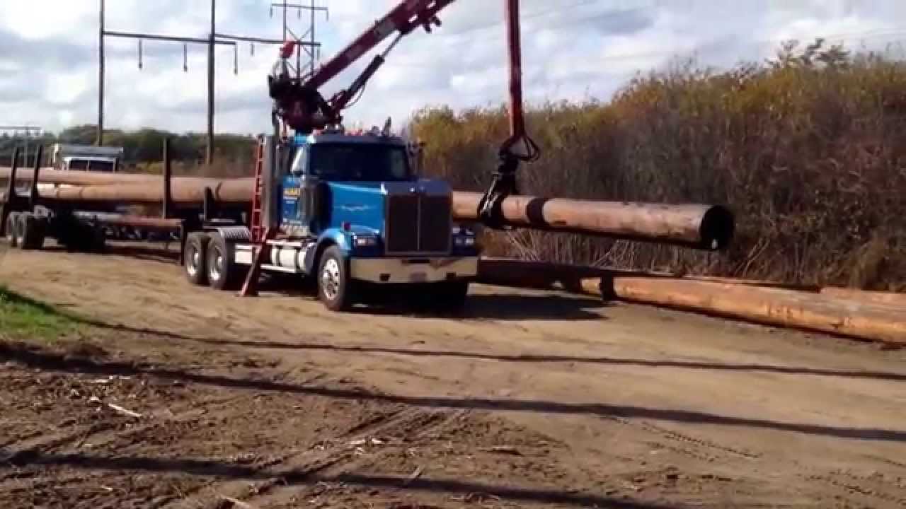 Unloading A Load of Poles - YouTube