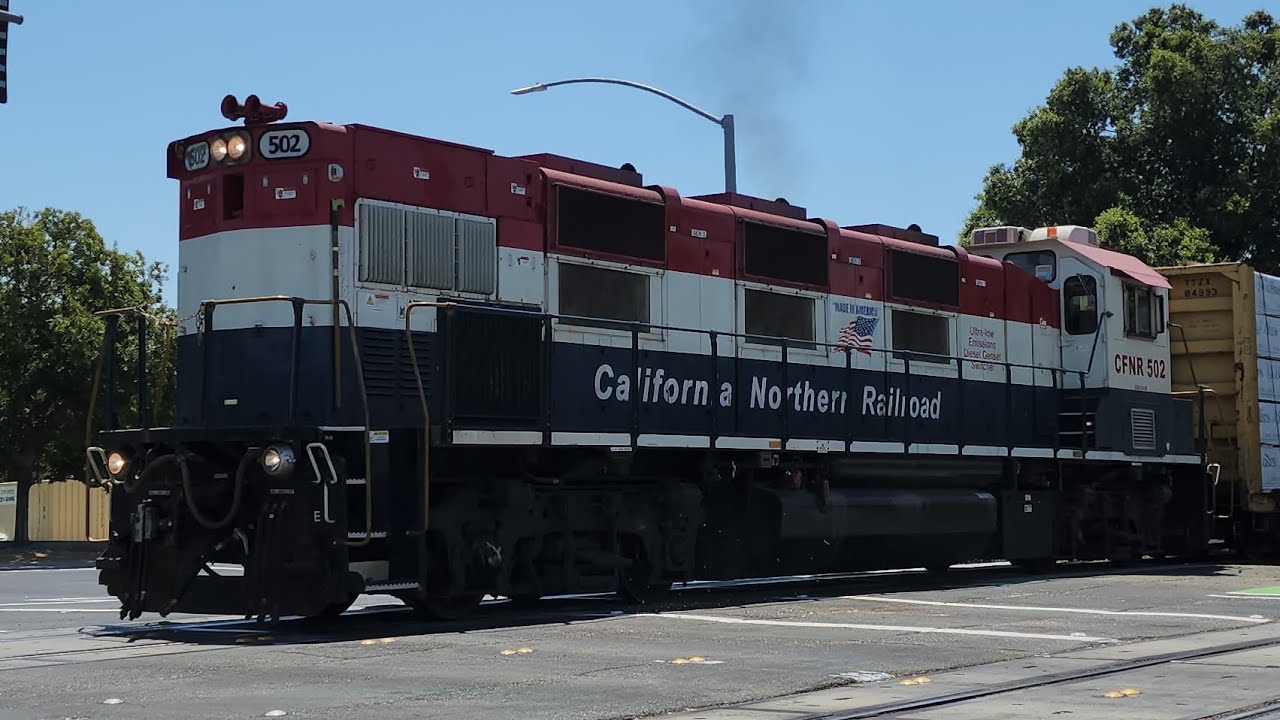 California Northern Genset Locomotive Leads a Train Through Woodland ...