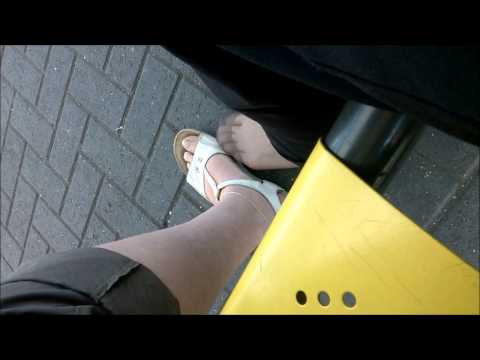 cd wearing tights playing footsie with woman at bus stop