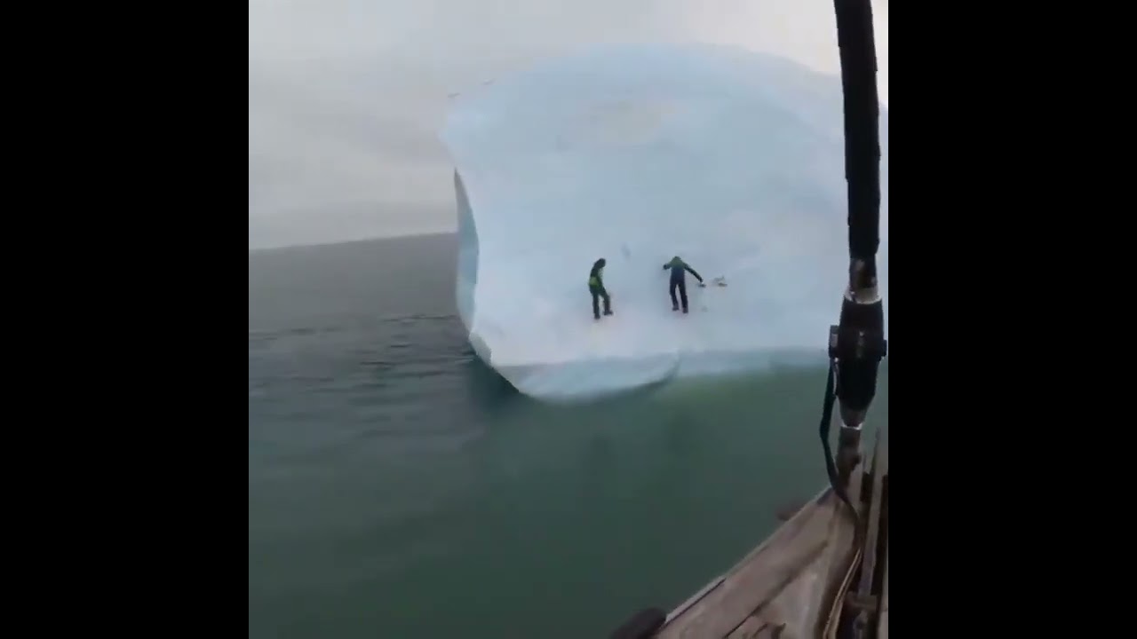 The Giant Iceberg Flipping as explorers try to Climb it.. - YouTube