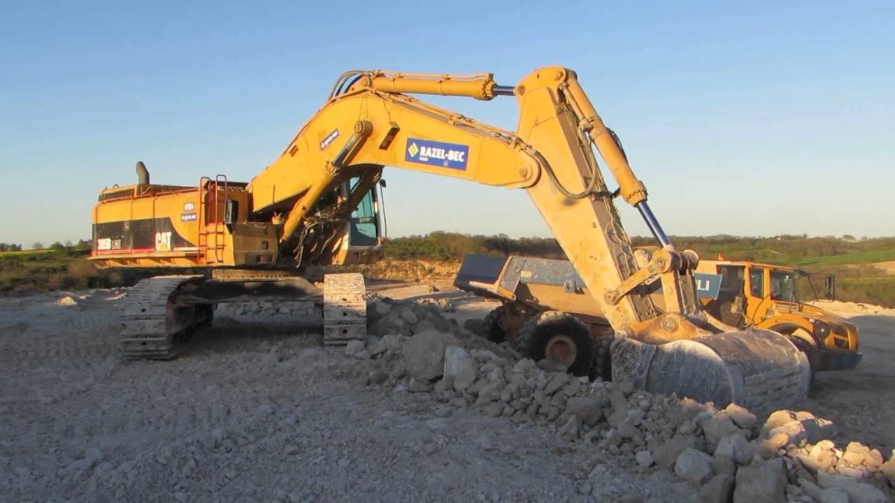 Caterpillar 385B loading Volvo A40F and Bell B45D - Part 3 - YouTube