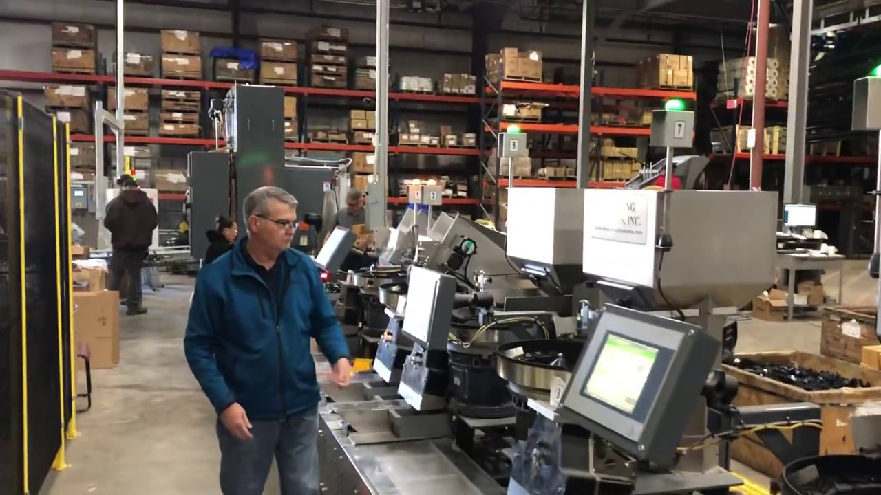 Large kit line with hand feed stations - YouTube