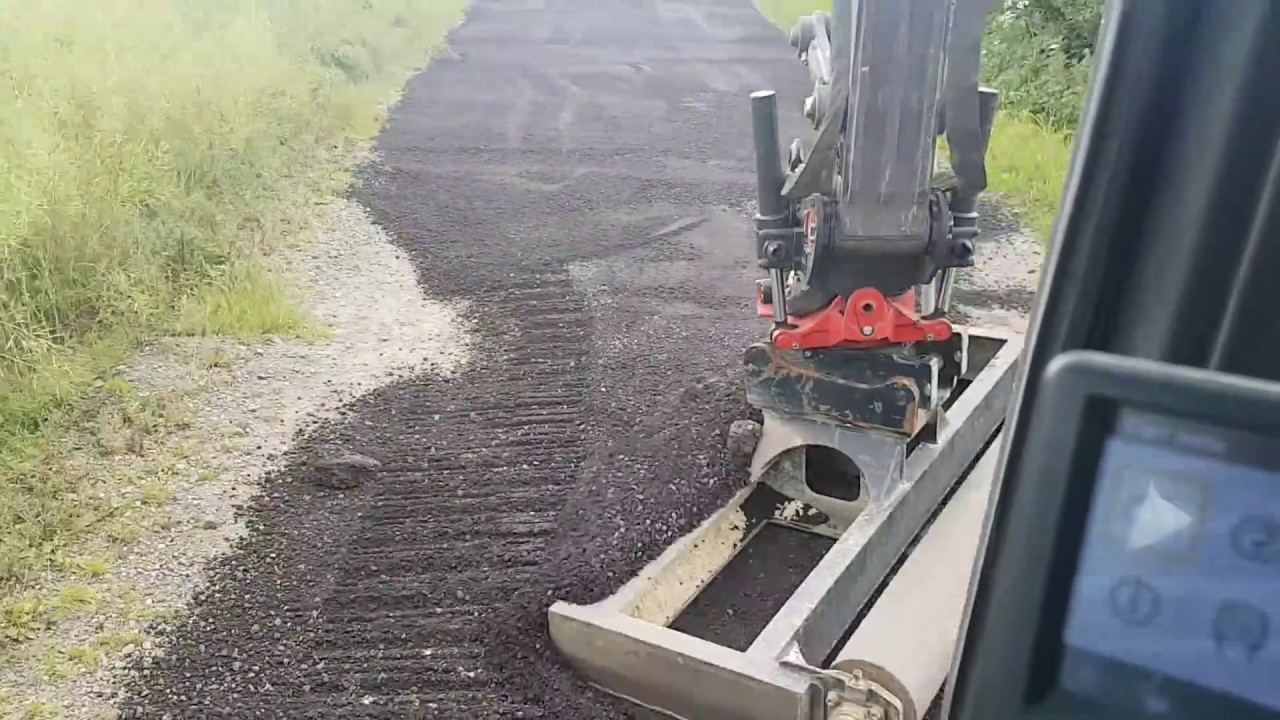 Levelling road planings on a farm track - YouTube