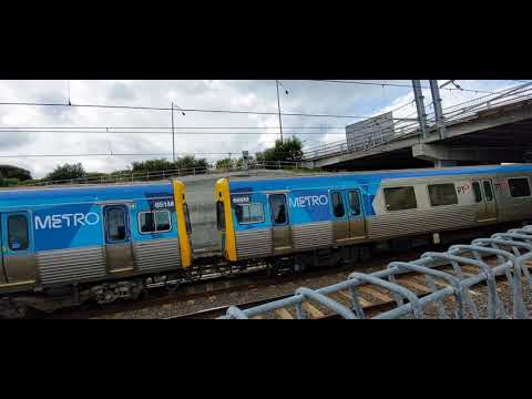 Australian Metro trains go fast past me as I film from Kananook Station ...