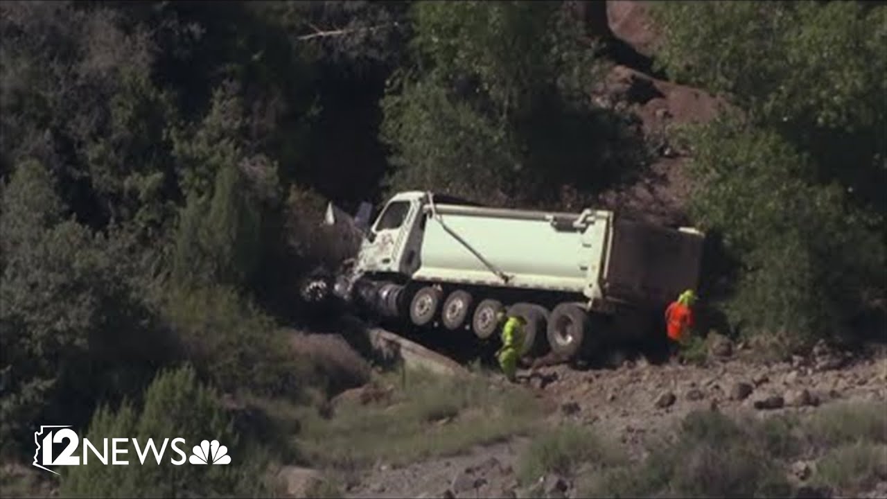 Dump truck veers offroad, hanging over culvert near I-17 - YouTube