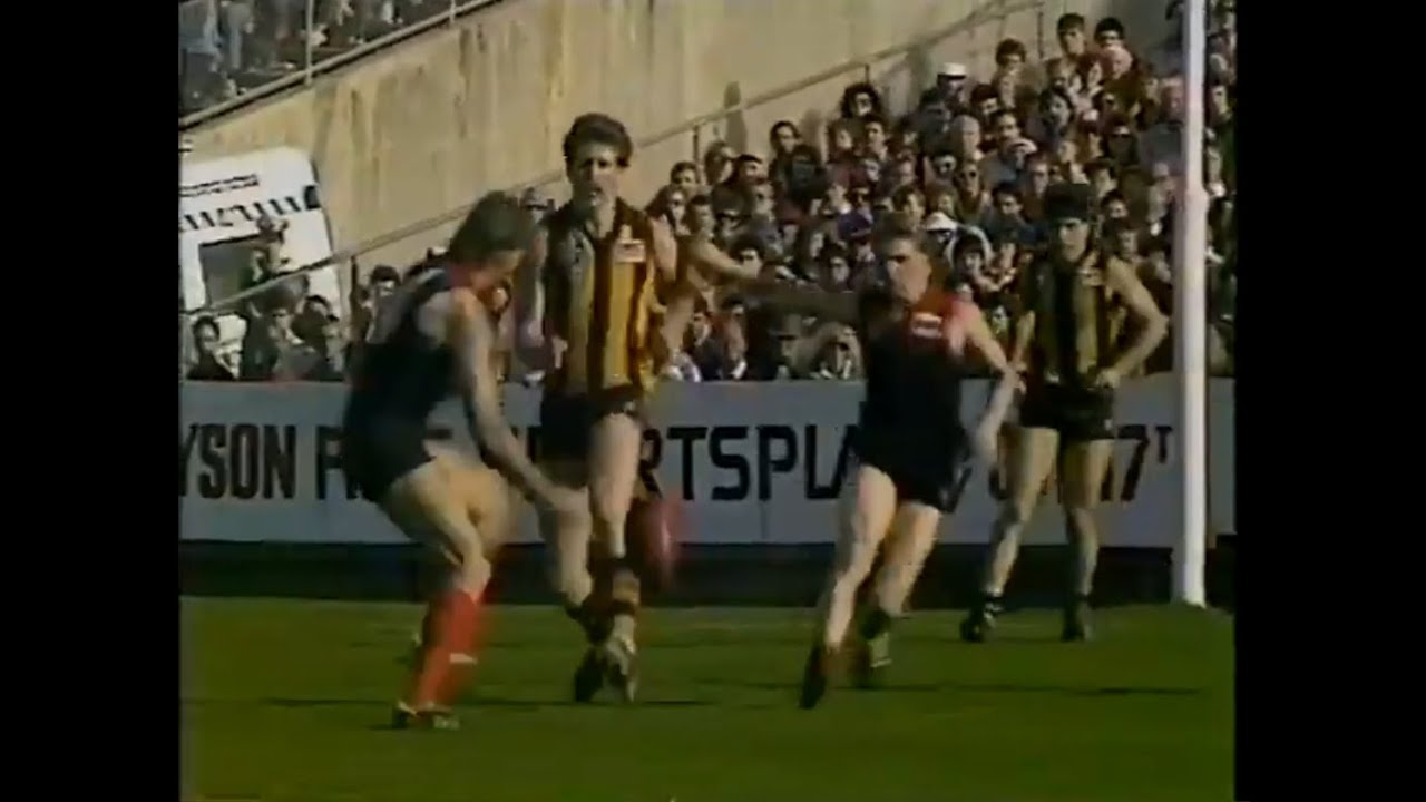 Big hip & shoulder by Melbourne's Rod Grinter on Hawthorn's Chris Mew ...