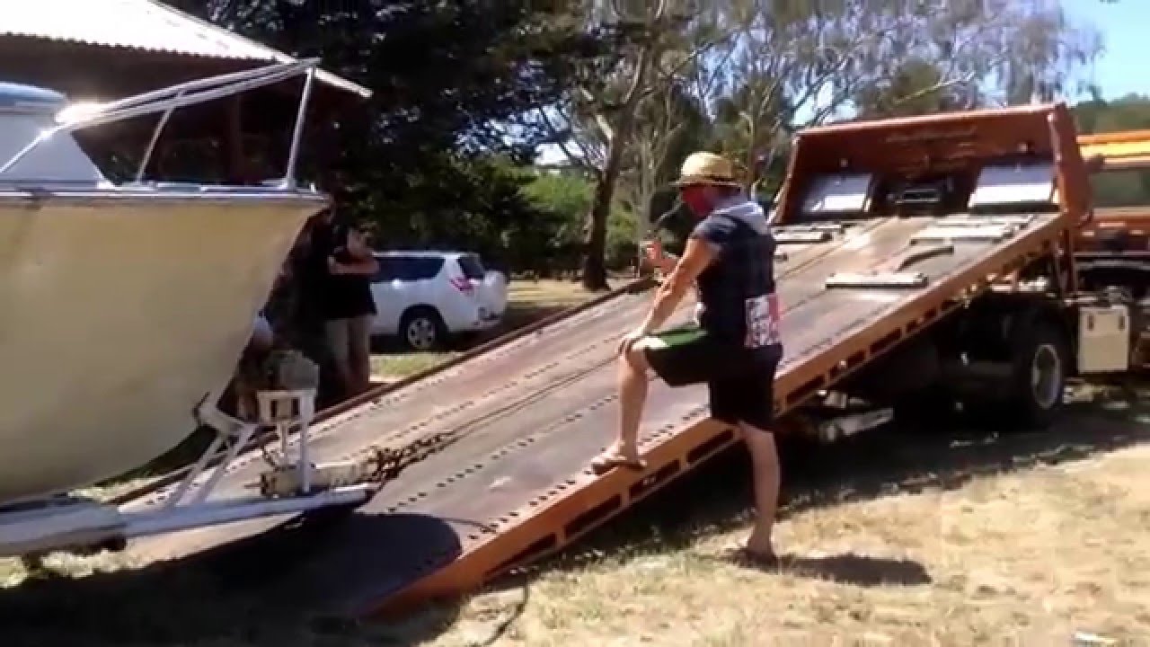 Loading boat onto tow truck - YouTube