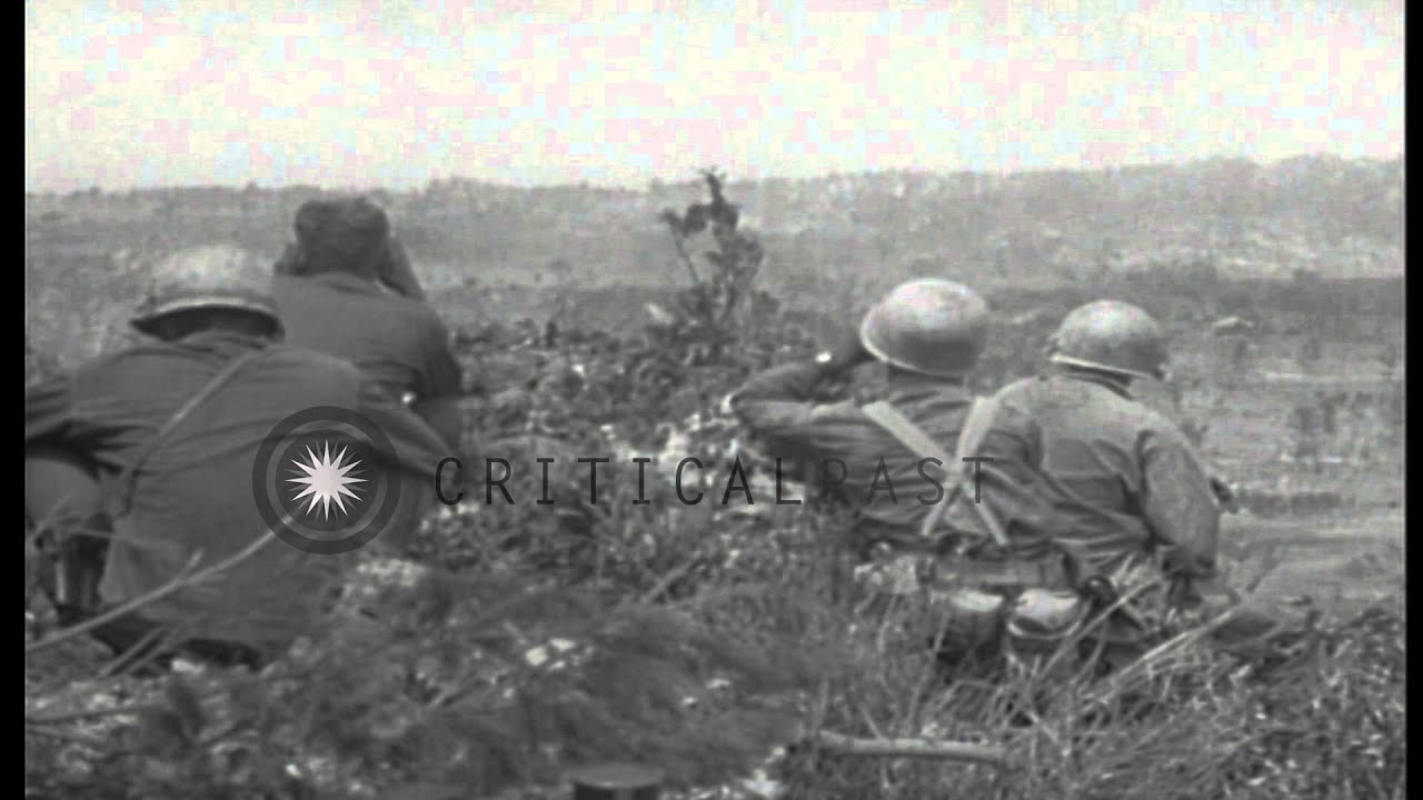 US 96th Division,381st Infantry soldiers advance behind a tank and ...