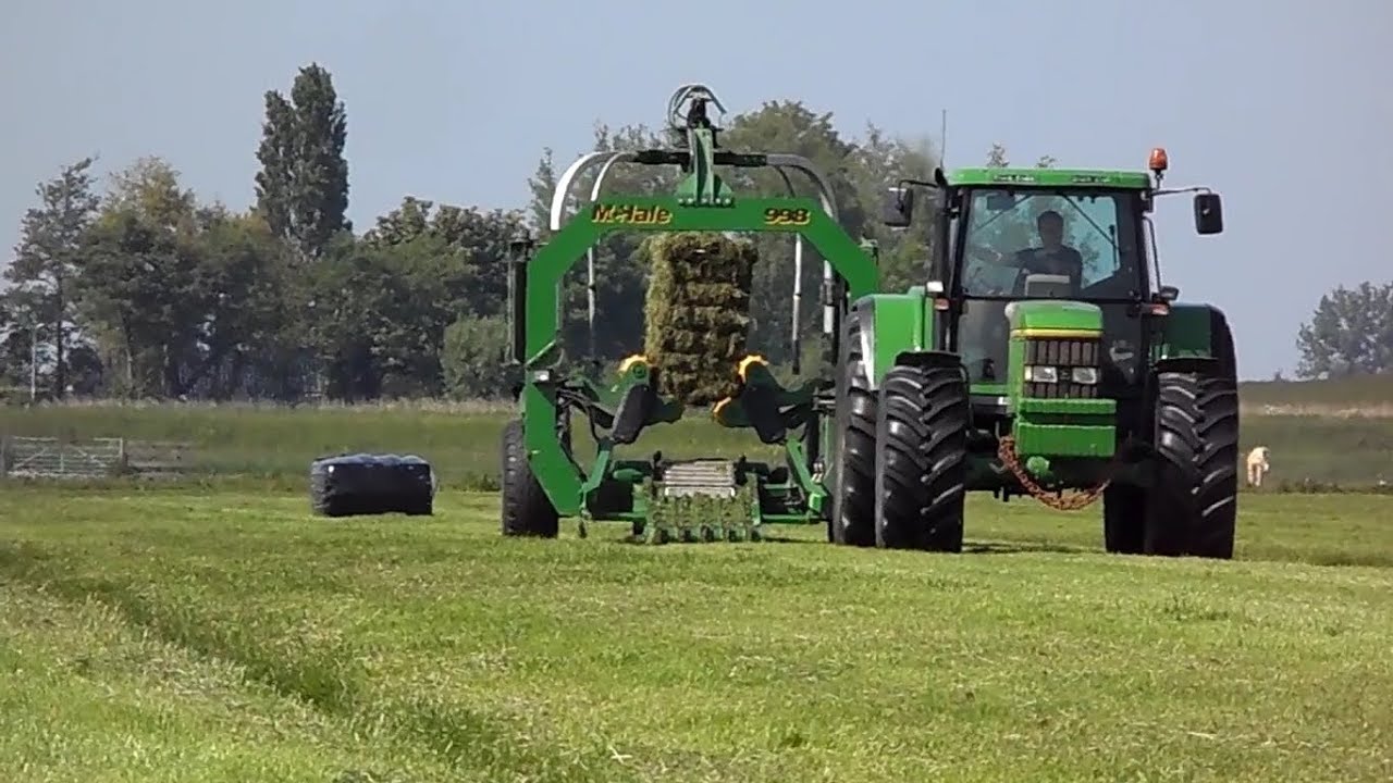 Wrapping and stacking square bales with John Deere and Deutz - YouTube
