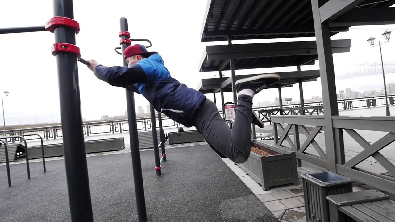 acrobat teenager jumping in sports grounds performing a backflip slow ...
